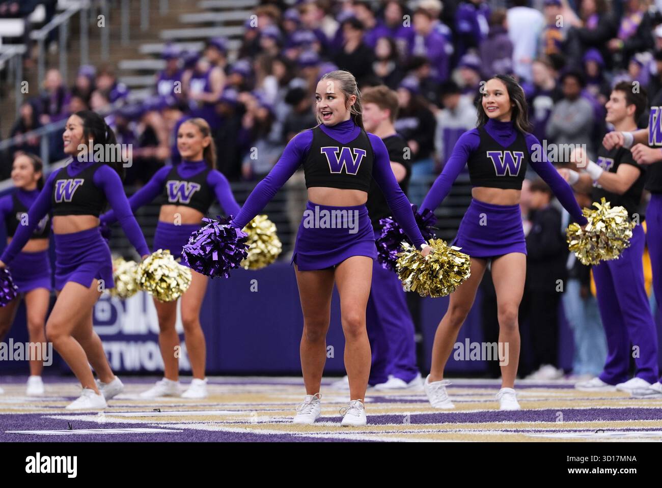 The Washington cheer team performs before an NCAA college football game ...
