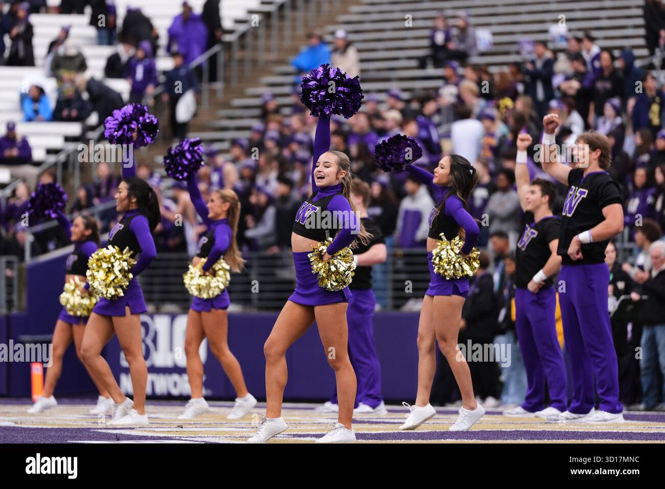 The Washington cheer team performs before an NCAA college football game ...