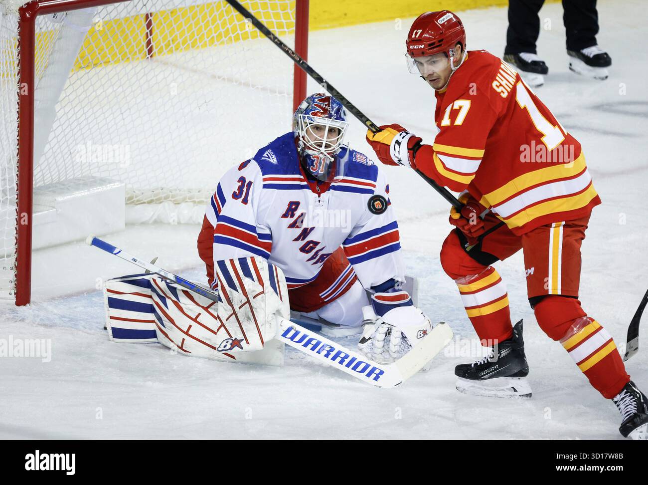 New York Rangers goalie Igor Shesterkin, left, deflects a shot by ...