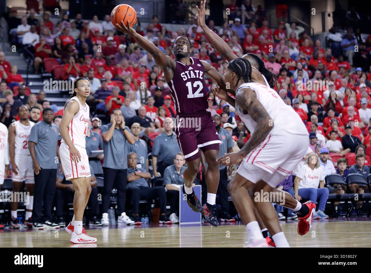 Mississippi State guard Josh Hubbard (12) goes up to shoot between Houston guard Kingston ...