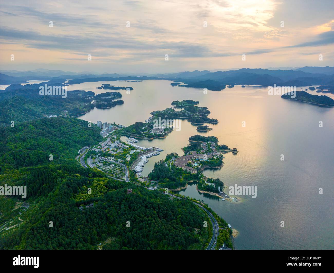 Aerial drone view following a winding road across the scenic green ...