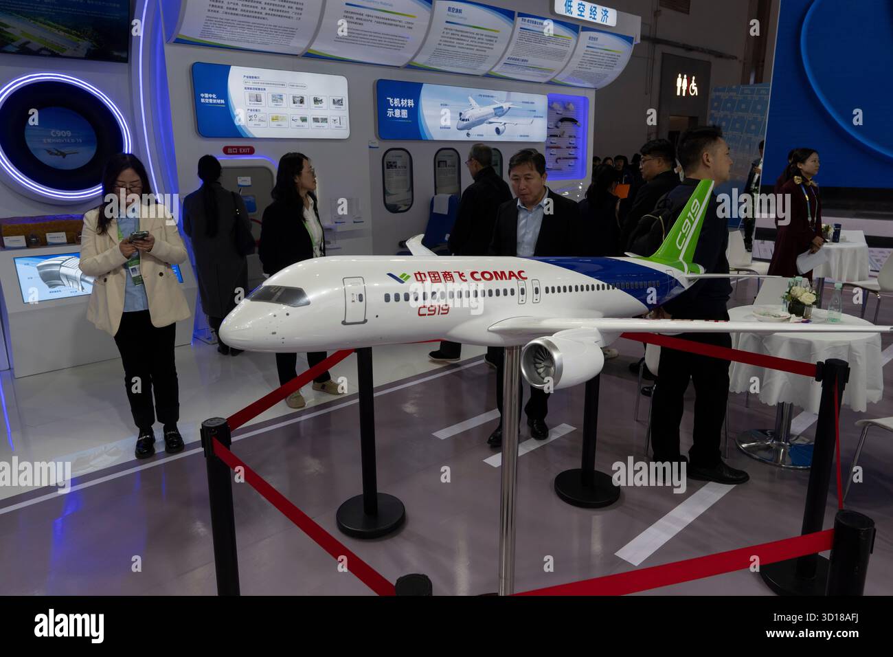 FILE - Attendees pass by a model of the Chinese-made C919 passenger jet ...