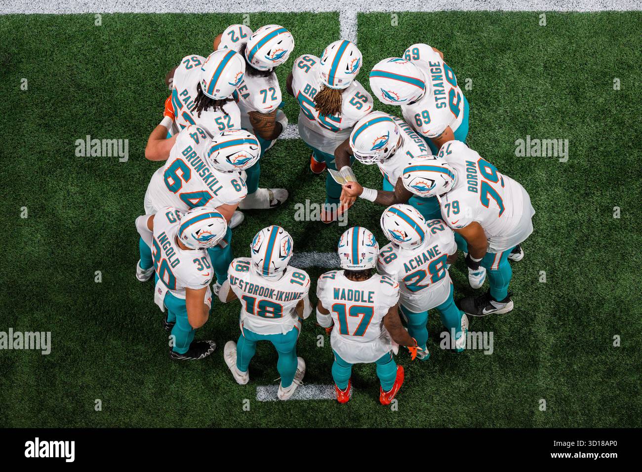 The Miami Dolphins offense huddles during the first half of an NFL ...