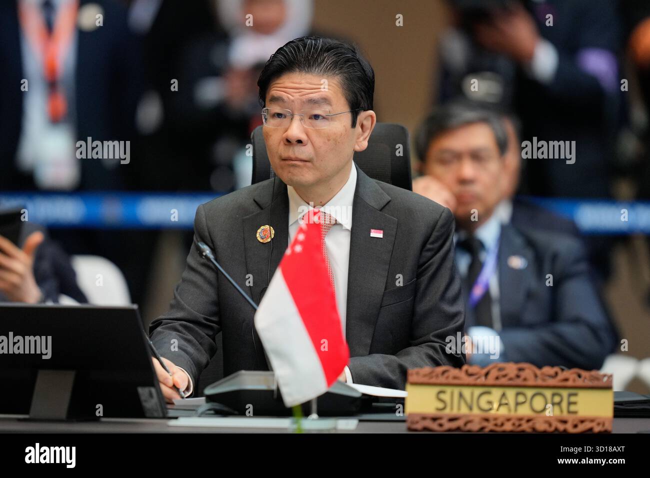 Singapore's Prime Minister Lawrence Wong listens to opening remark ...