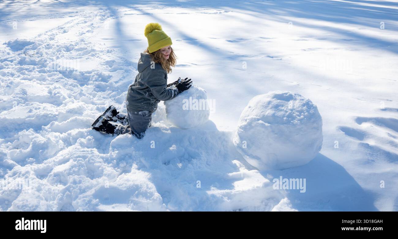 Happy winter. Child play with snowball. Kid playing in fresh snow under ...