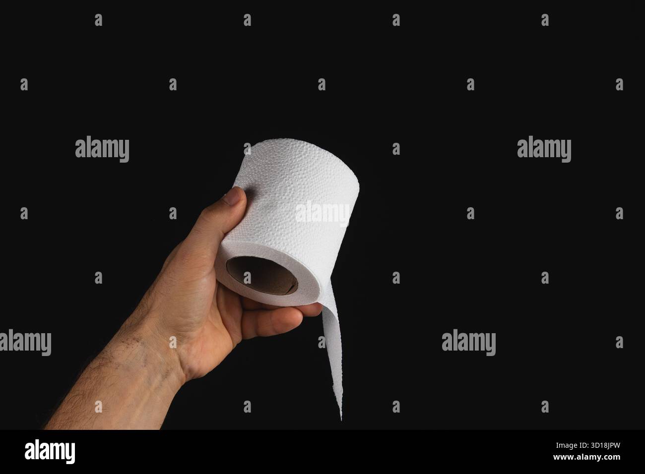 A person holds a roll of white tissue paper with the end partially ...