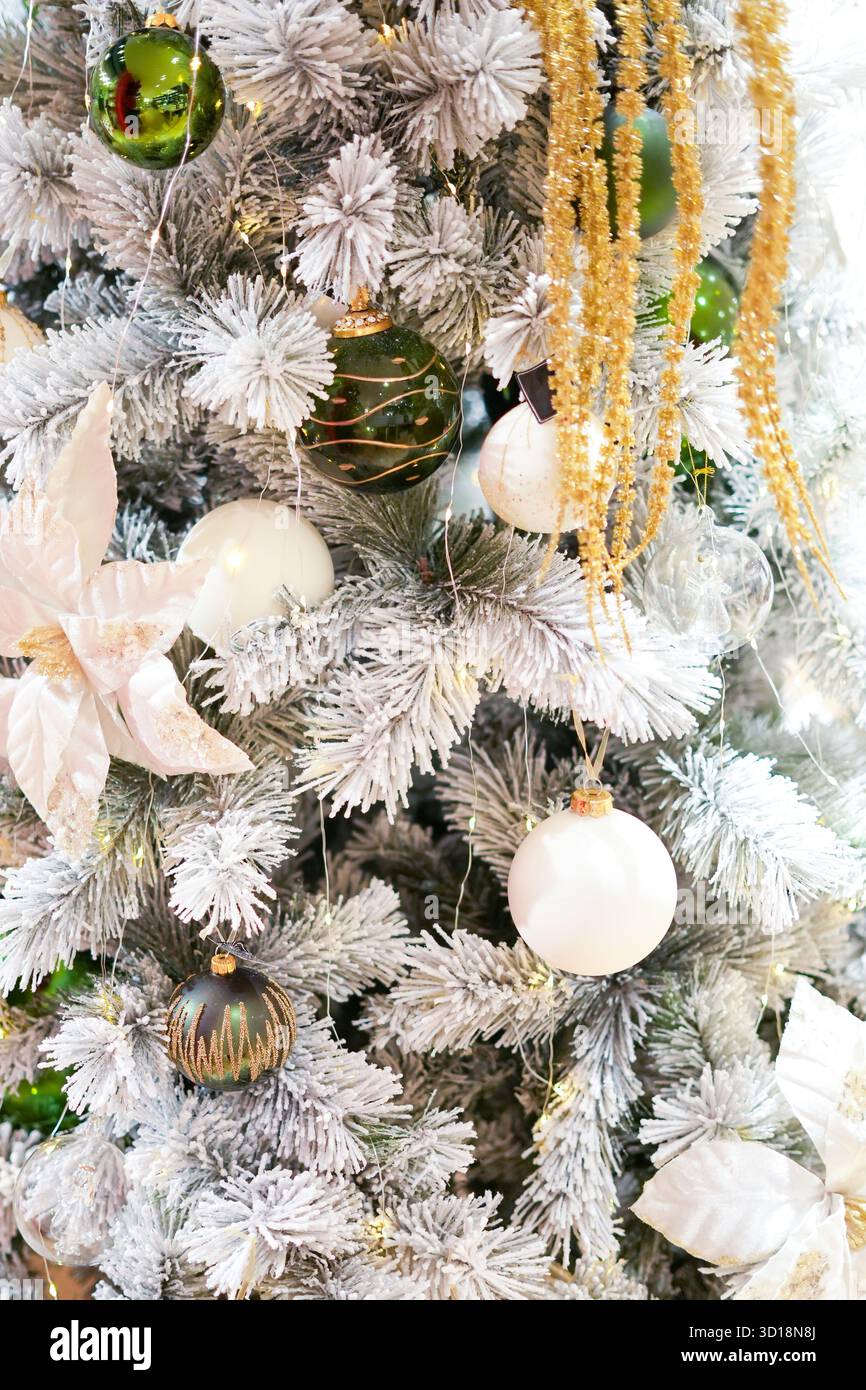 Frosted Christmas tree with green, gold, and white ornaments—elegant ...