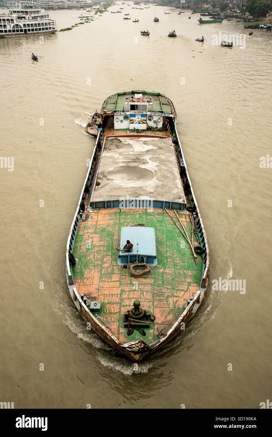 Aerial View Of A Large Cargo Ship Navigating A Busy River With Smaller ...