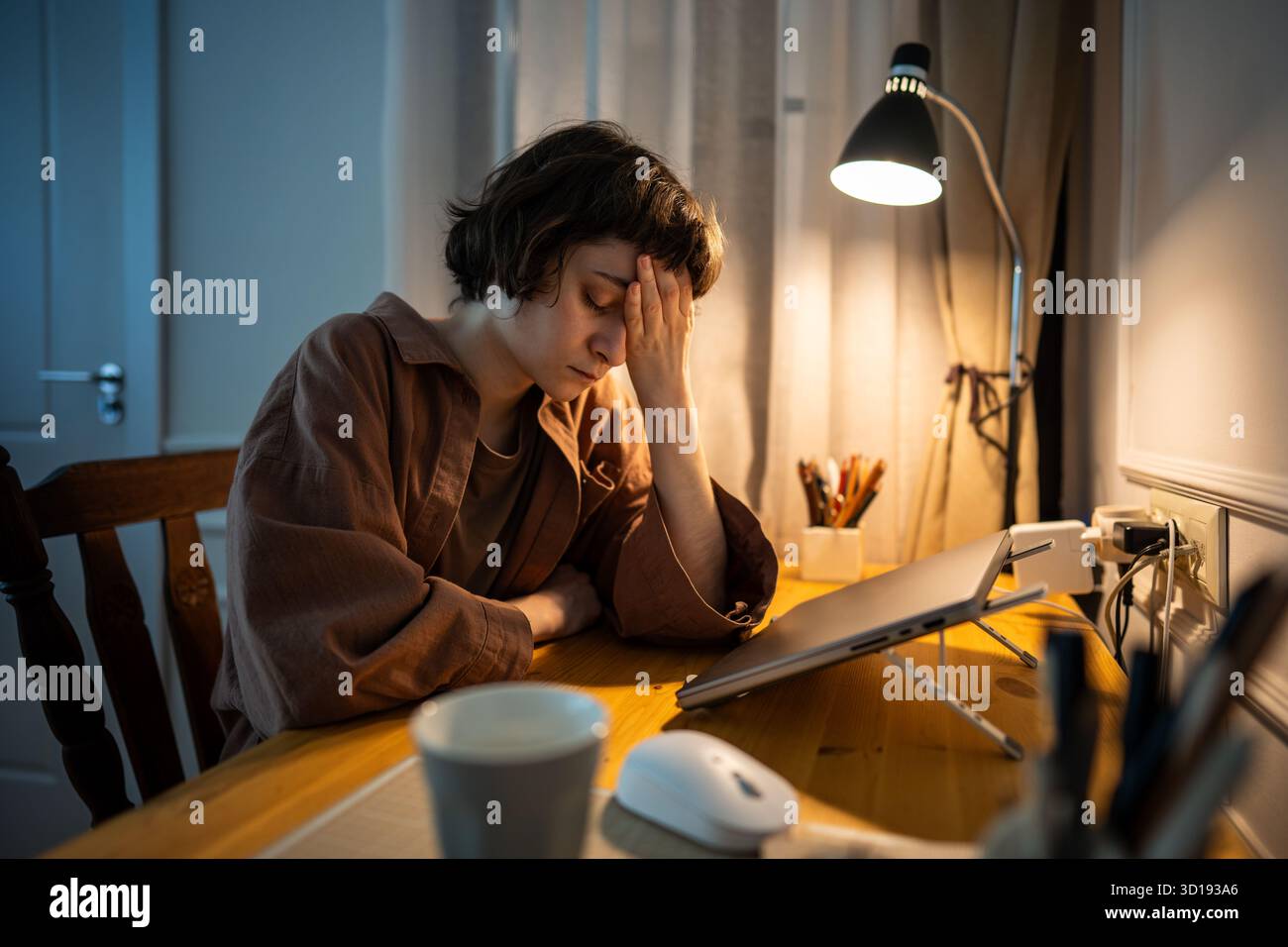 Young woman cradles face hands hi-res stock photography and images - Alamy