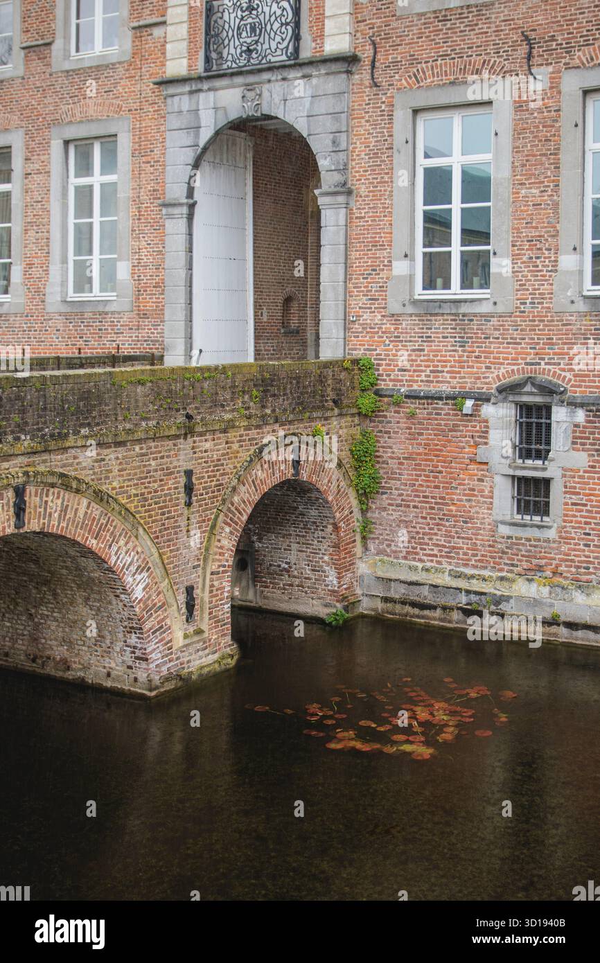 Ancient medieval castle gates are surrounded by a bridge and pond in ...