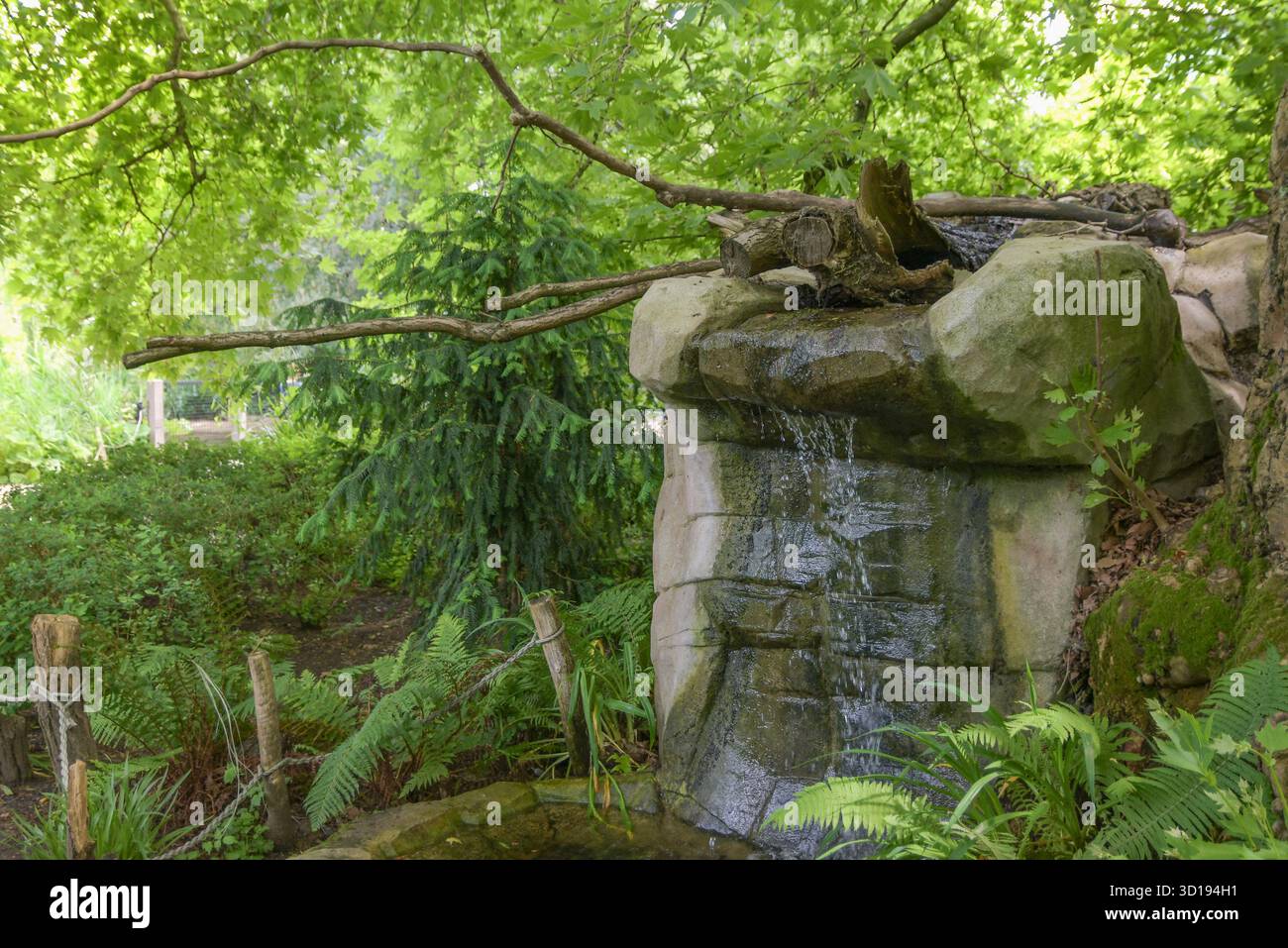 Decorative small waterfall made of stacked stones in a park area Stock ...
