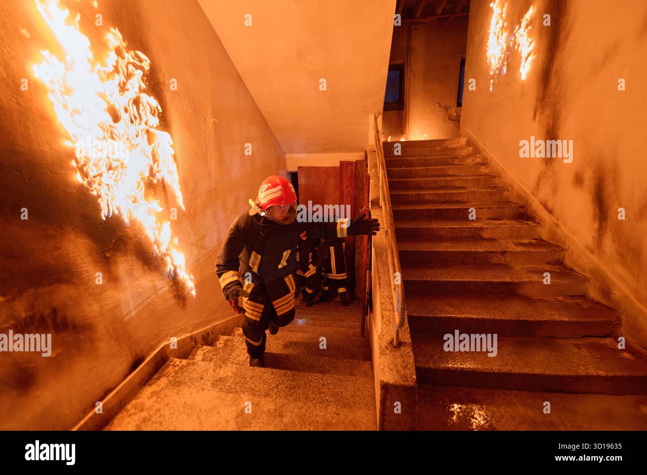 Firefighters in action, battling flames on a staircase, emergency ...