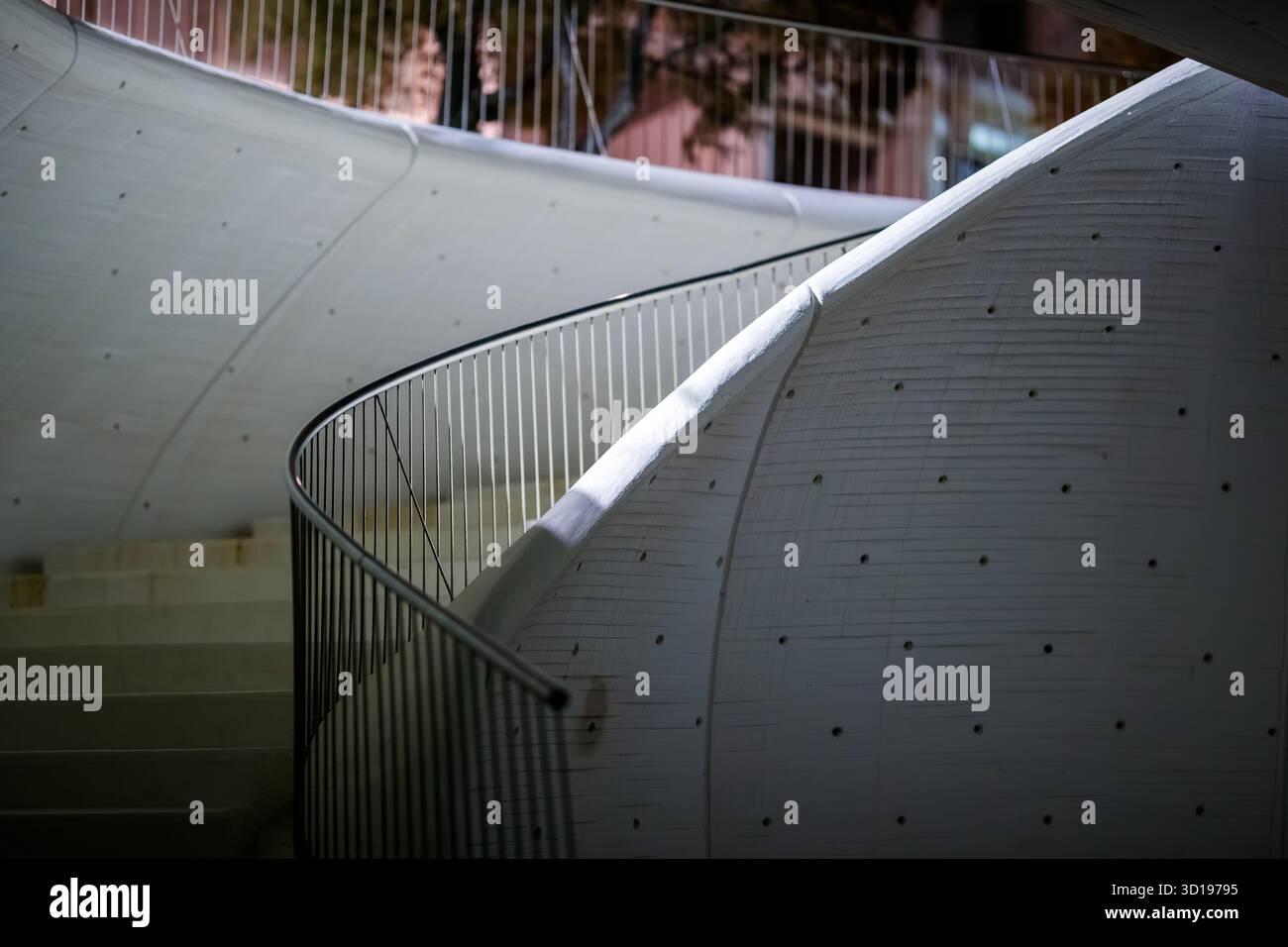 Spiral Ascent: Curved Staircase and Wavy Wall at Night Stock Photo - Alamy
