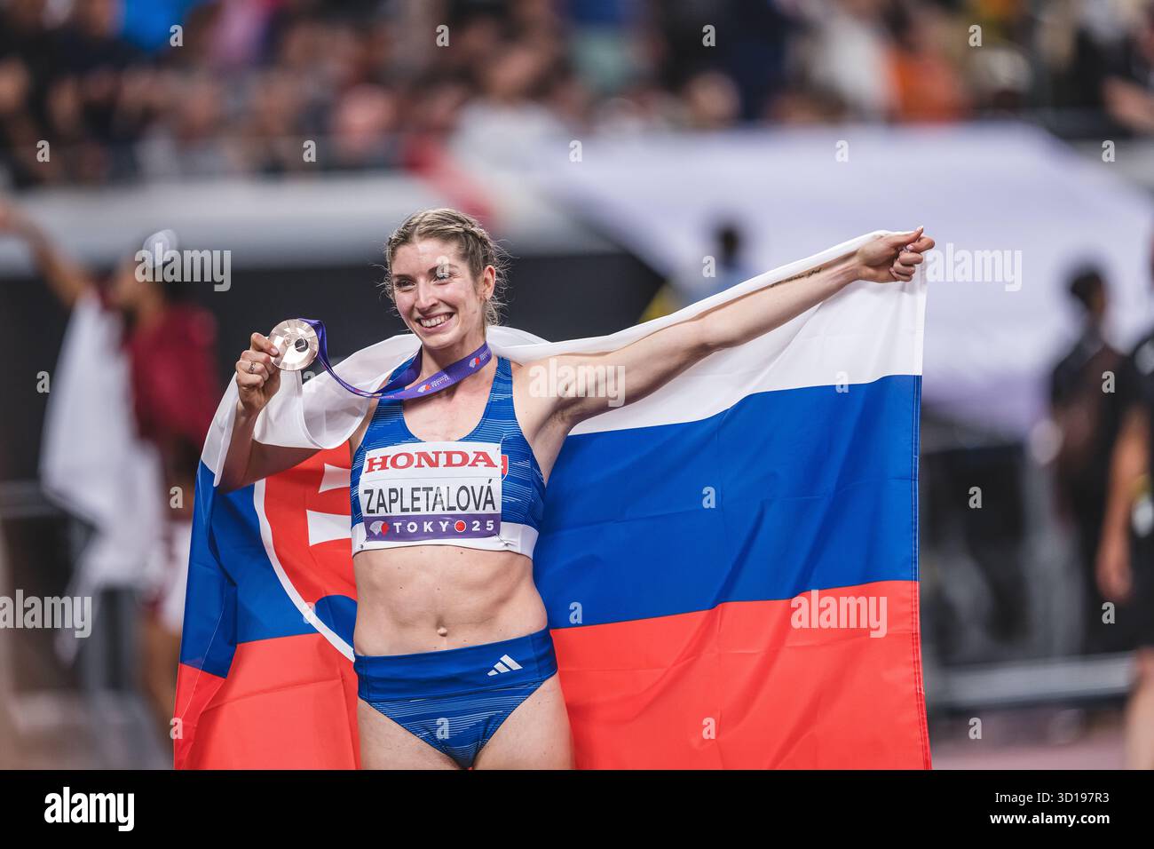 Emma Zapletalová celebrating her medal with her country's flag at the ...