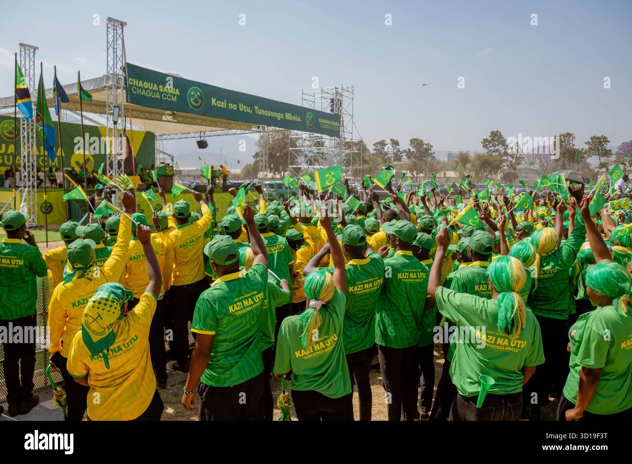 Supporters of Tanzanian President Samia Suluhu Hassan wave flags during ...
