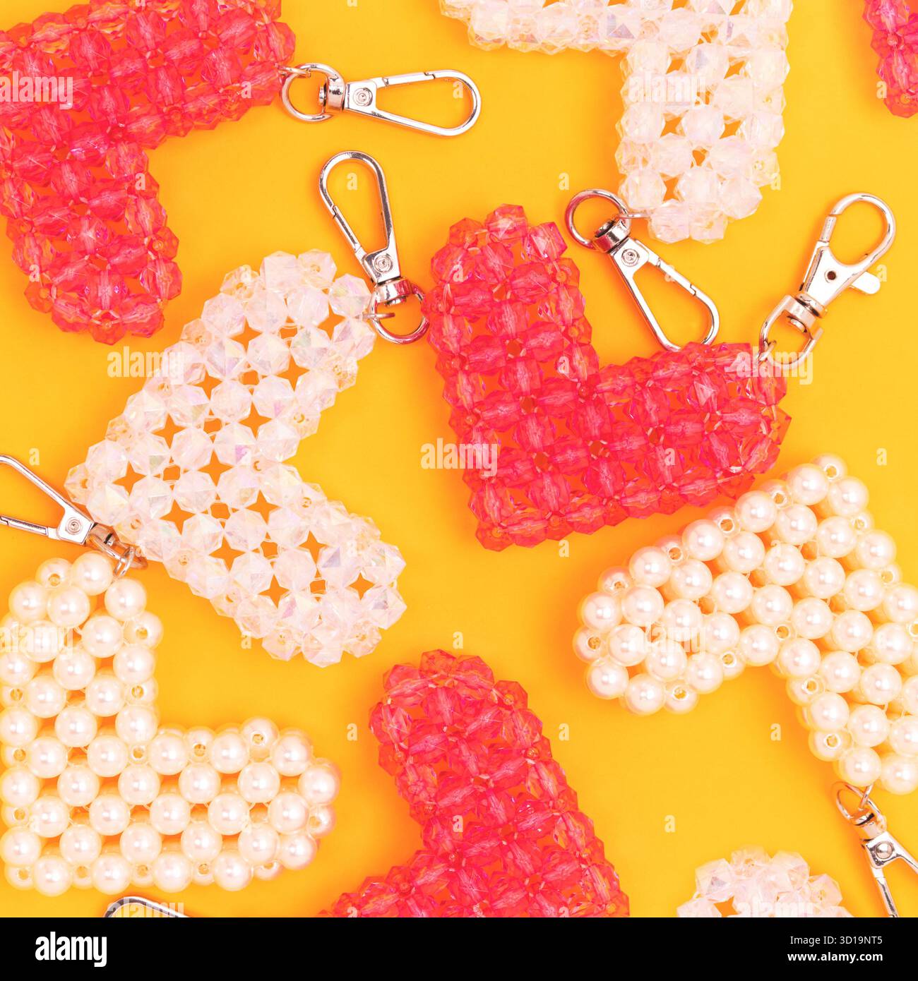 Various handmade keychains in a heart shape made from acrylic beads ...