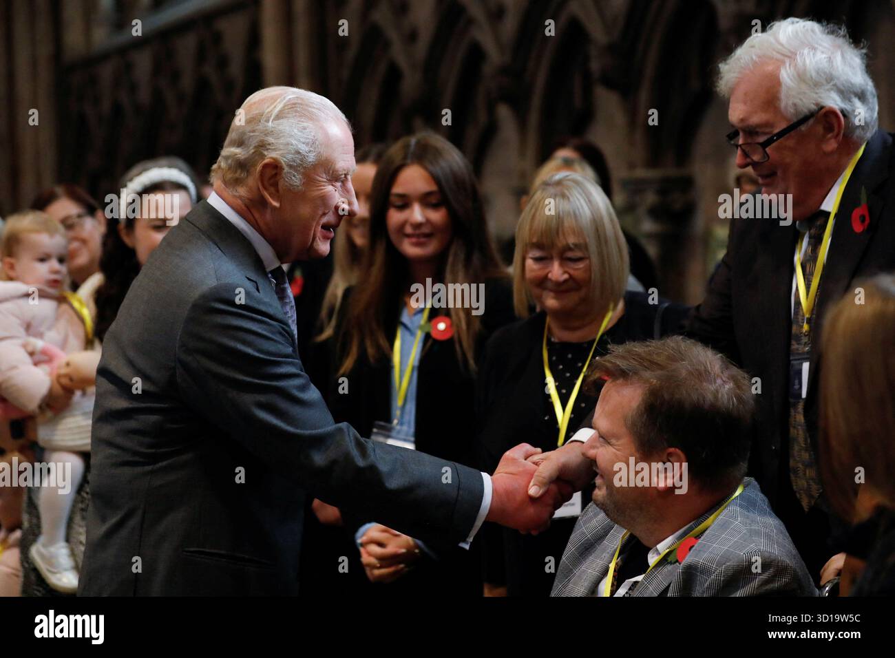 Britain's King Charles III shakes hands with a man as he meets community groups during his visit ...