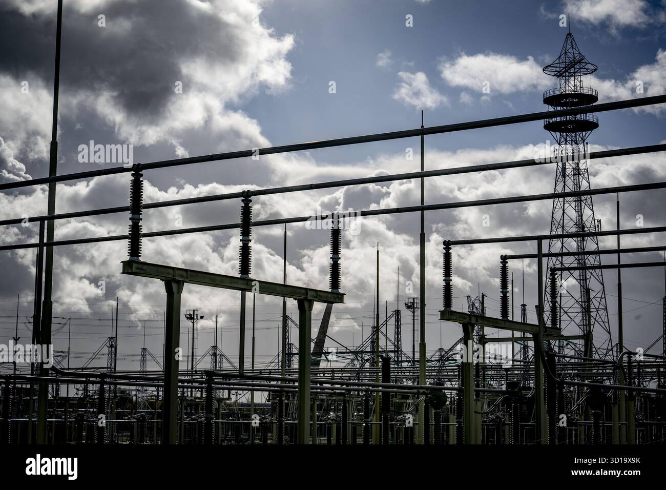 DIEMEN - A Tennet power station. High-voltage pylons dot the landscape ...