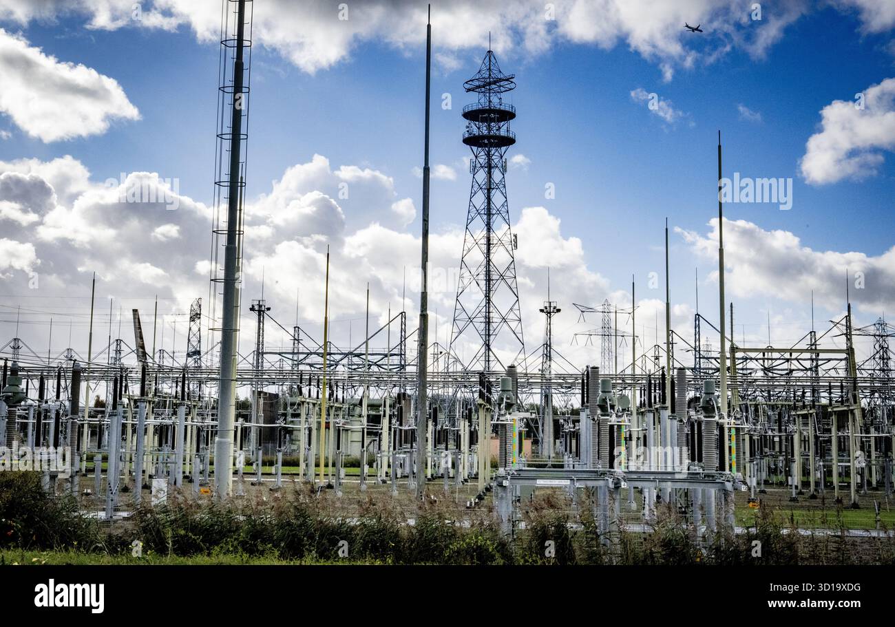 DIEMEN - A Tennet power station. High-voltage pylons dot the landscape ...