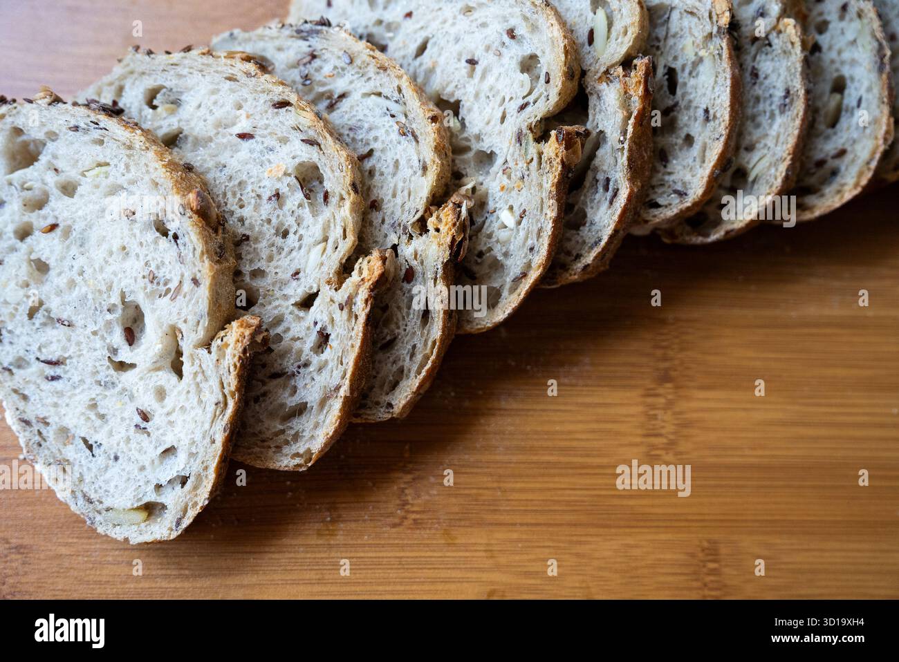 Freshly cut sourdough bread slices stacked diagonally, perfect for food ...