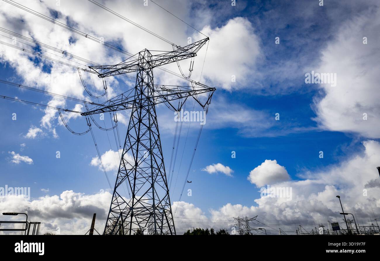 DIEMEN - A Tennet power station. High-voltage pylons dot the landscape ...