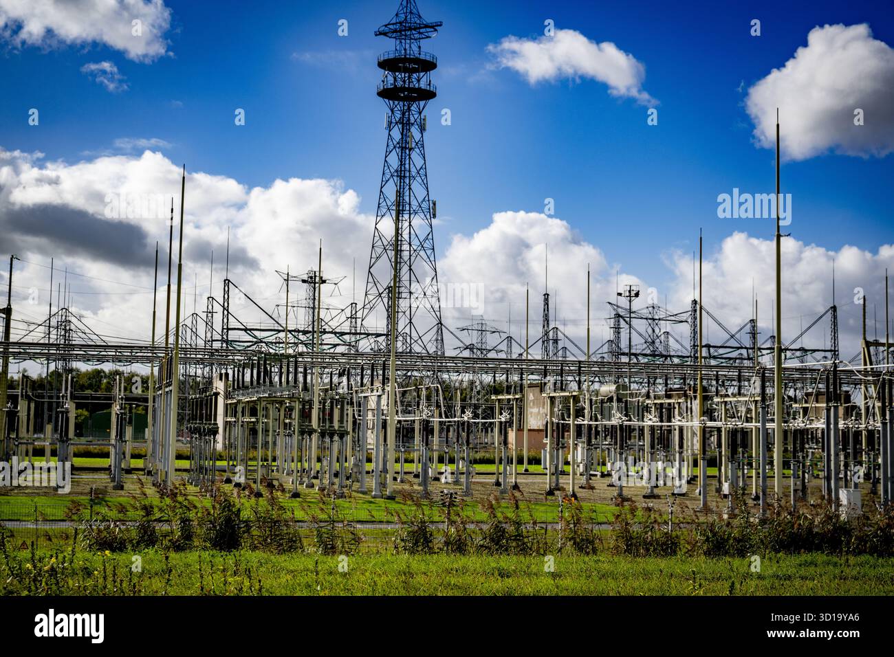 DIEMEN - A Tennet power station. High-voltage pylons dot the landscape ...