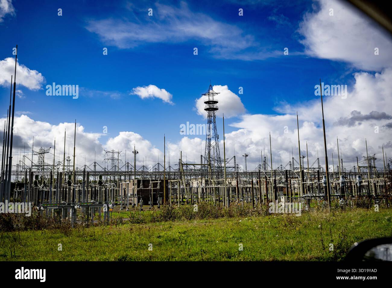 DIEMEN - A Tennet power station. High-voltage pylons dot the landscape ...