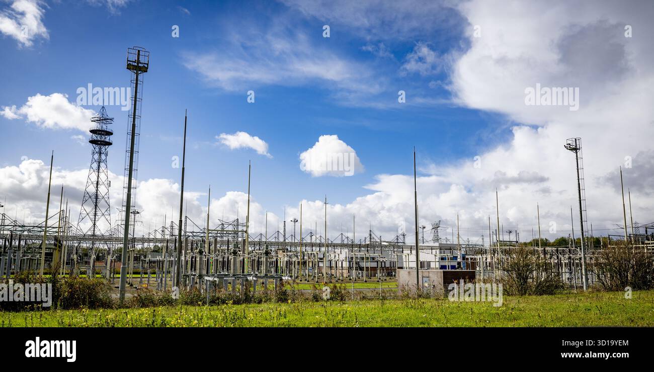 DIEMEN - A Tennet power station. High-voltage pylons dot the landscape ...