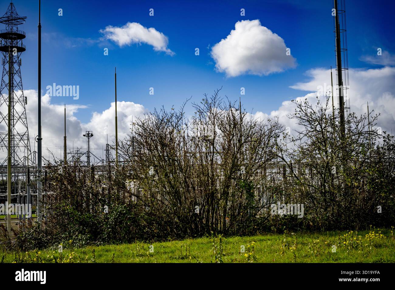 DIEMEN - A Tennet power station. High-voltage pylons dot the landscape ...