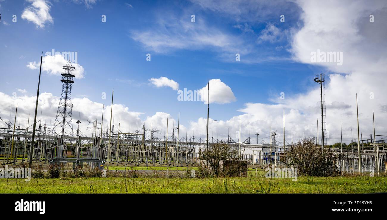 DIEMEN - A Tennet power station. High-voltage pylons dot the landscape ...