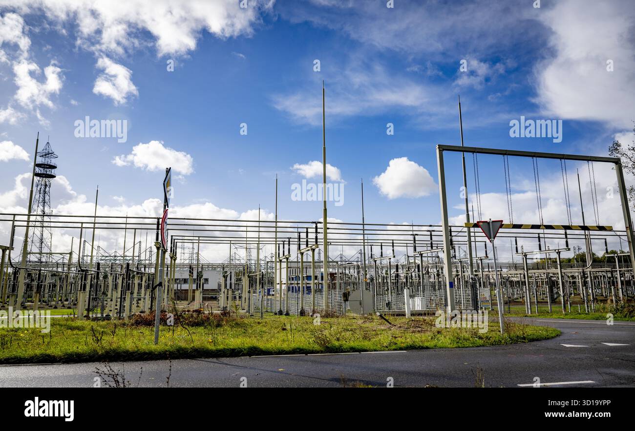 DIEMEN - A Tennet power station. High-voltage pylons dot the landscape ...