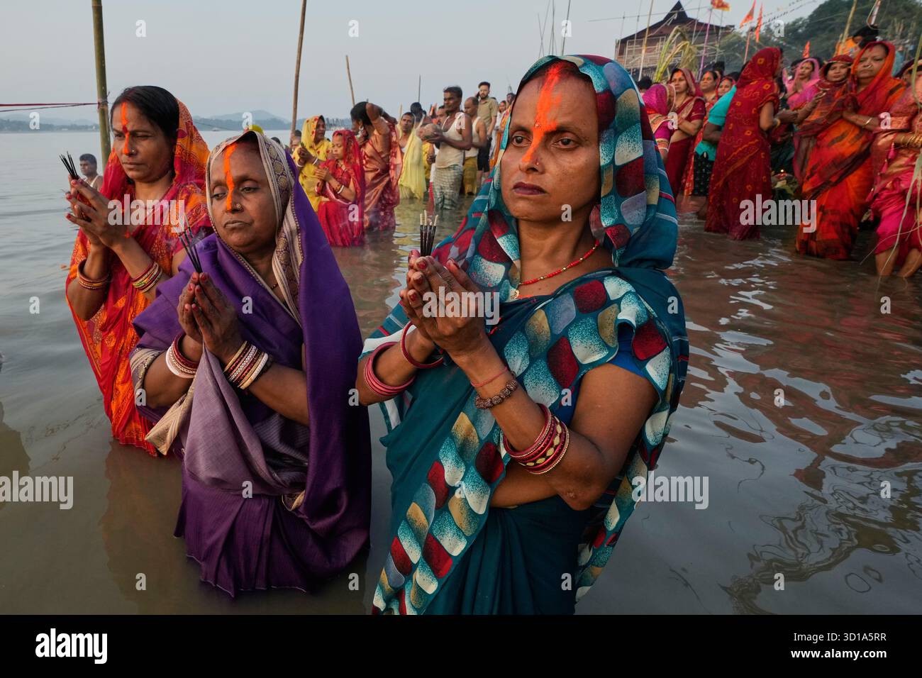 Indian Hindu devotees perform rituals in the the river Brahmaputra ...