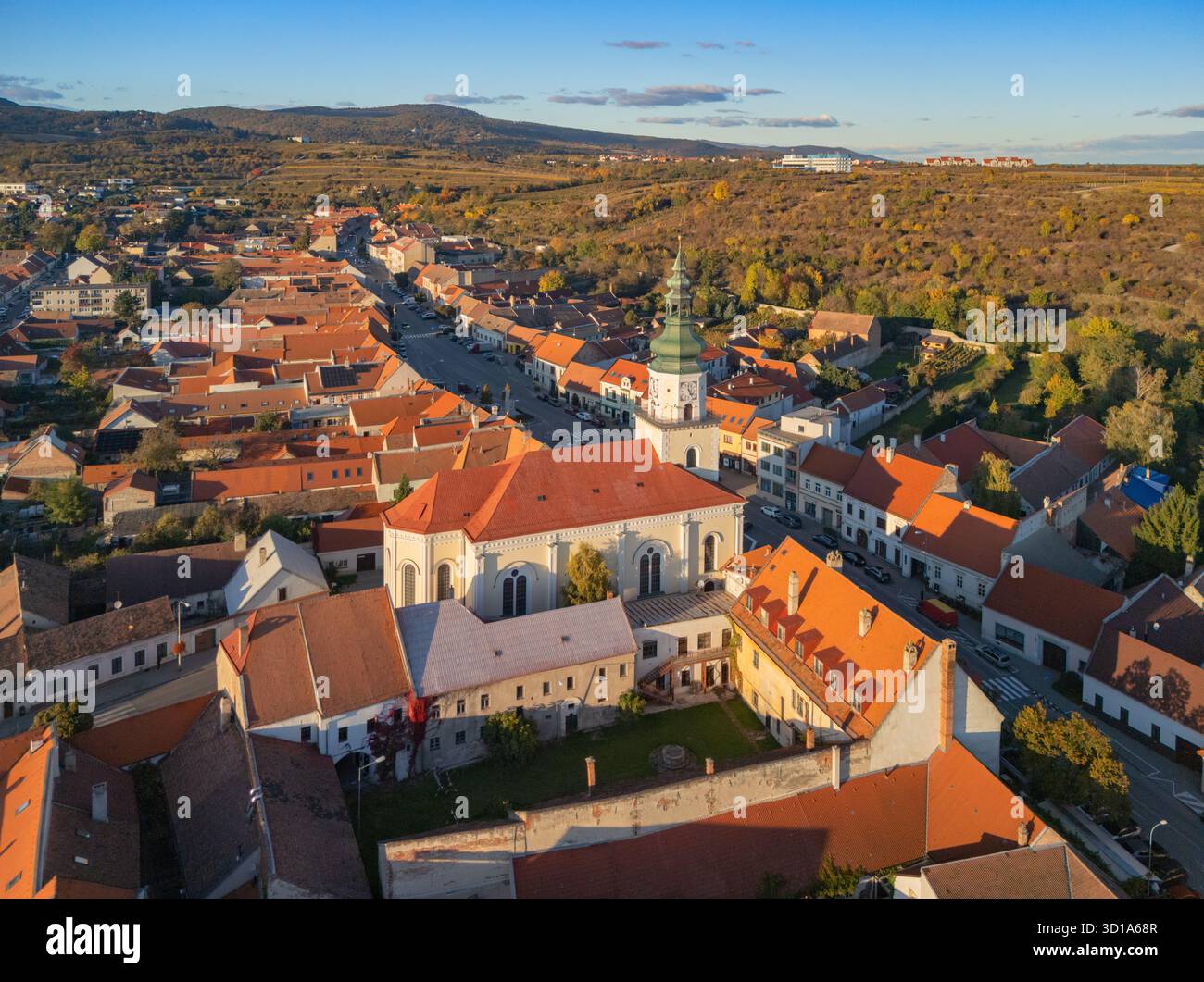 Aerial view of the captivating church tower rising amidst the cozy, red ...