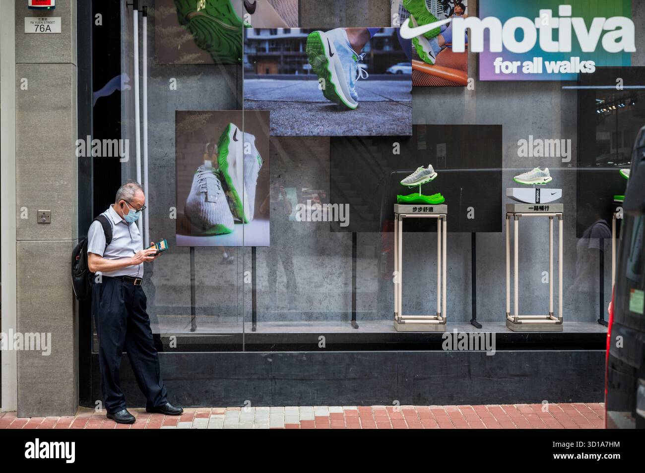 A man stands outside the American multinational sport clothing brand ...