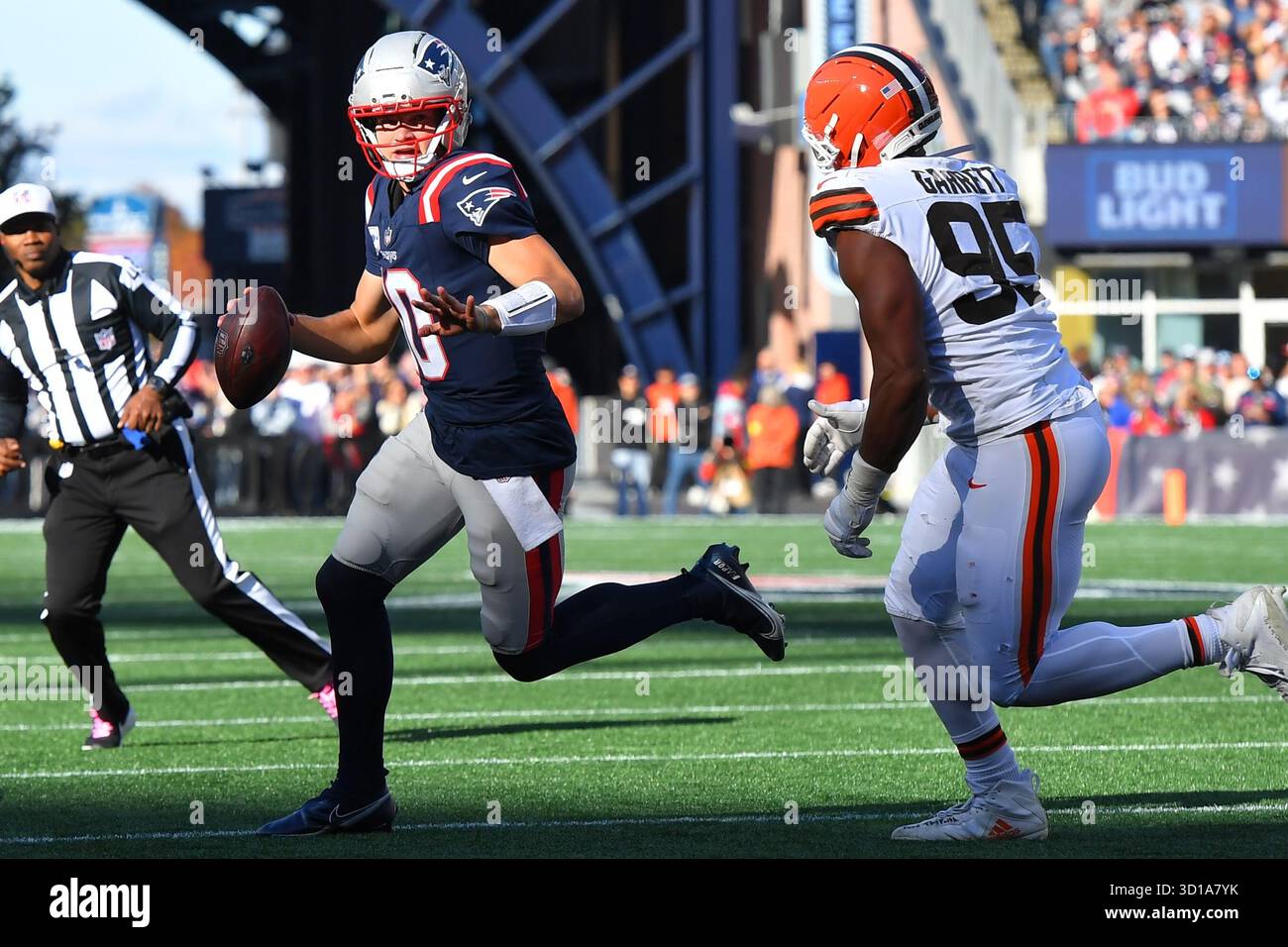 New England Patriots quarterback Drake Maye, left, runs under pressure ...