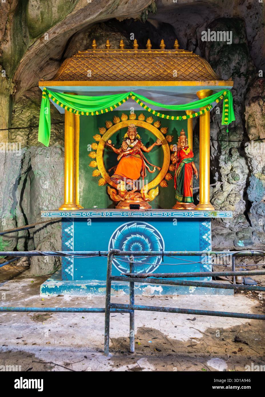 Hindu shrine with golden deities and colorful decorations inside Batu ...