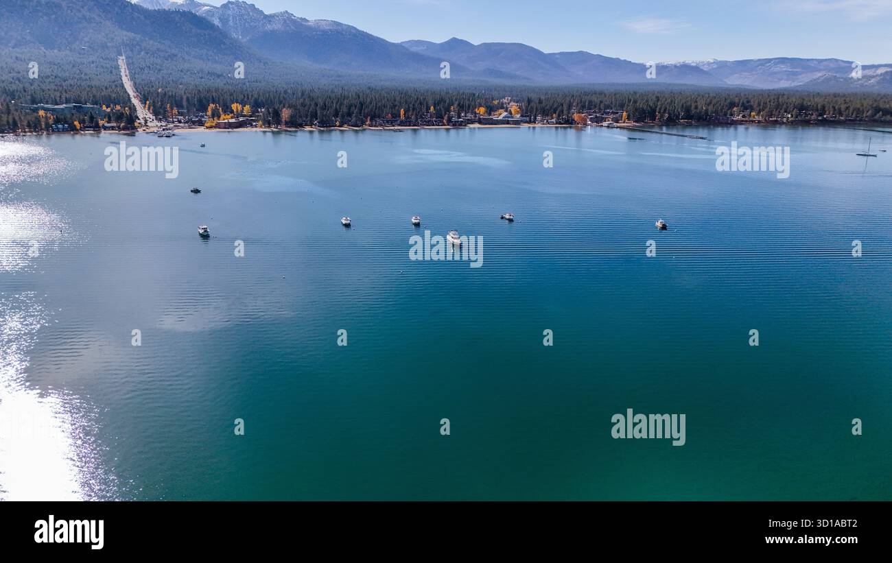 Aerial view of tranquil waters dotted with boats reflecting the clear ...