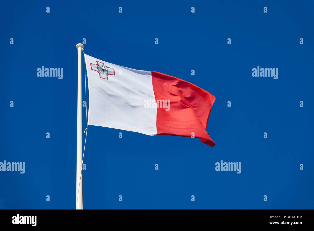 Malta Flag Flying Against Clear Blue Sky With Maltese Cross Emblem At ...