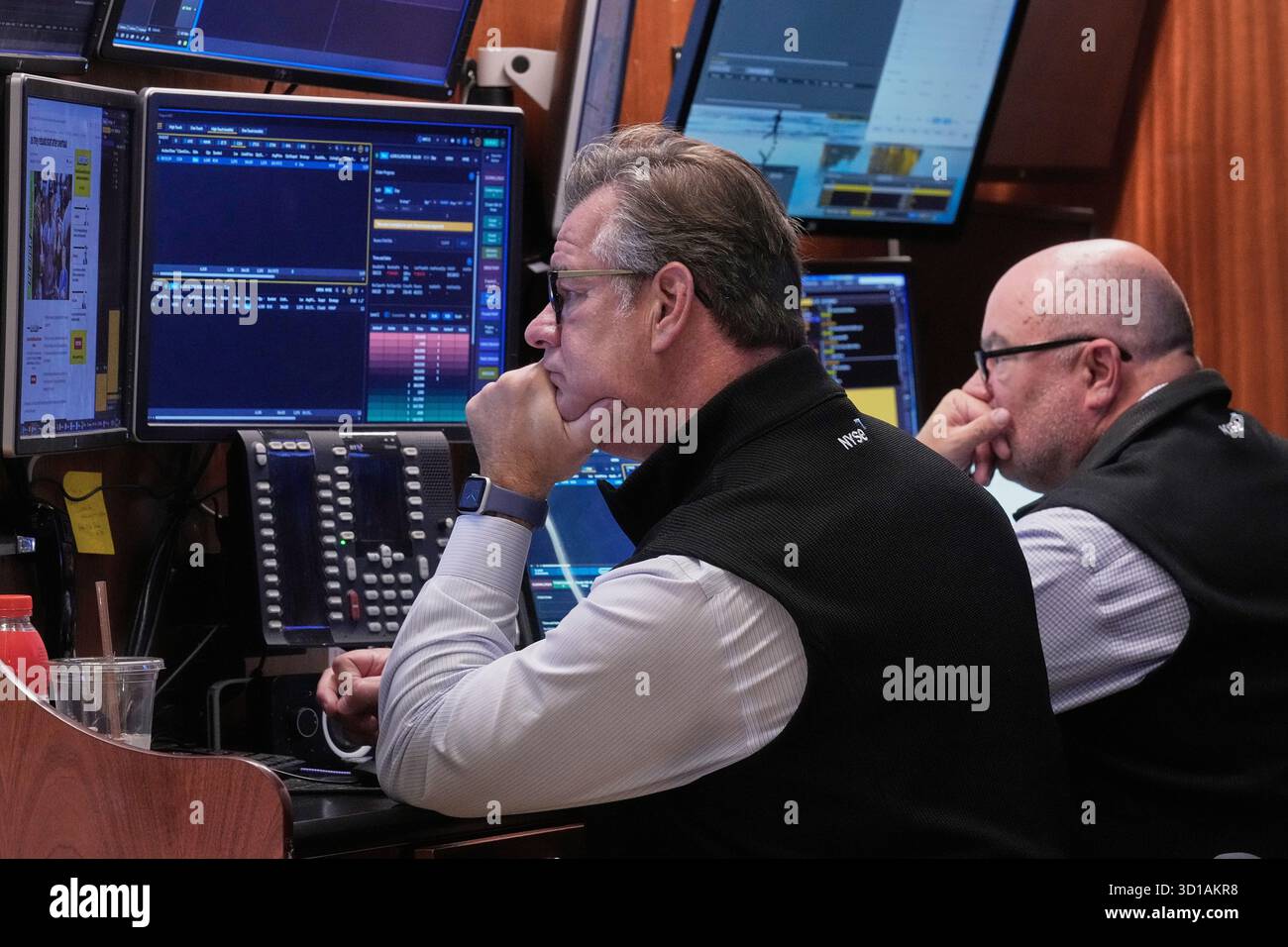 Traders Steve Capo, left, and Chris Morie work on the floor of the New ...