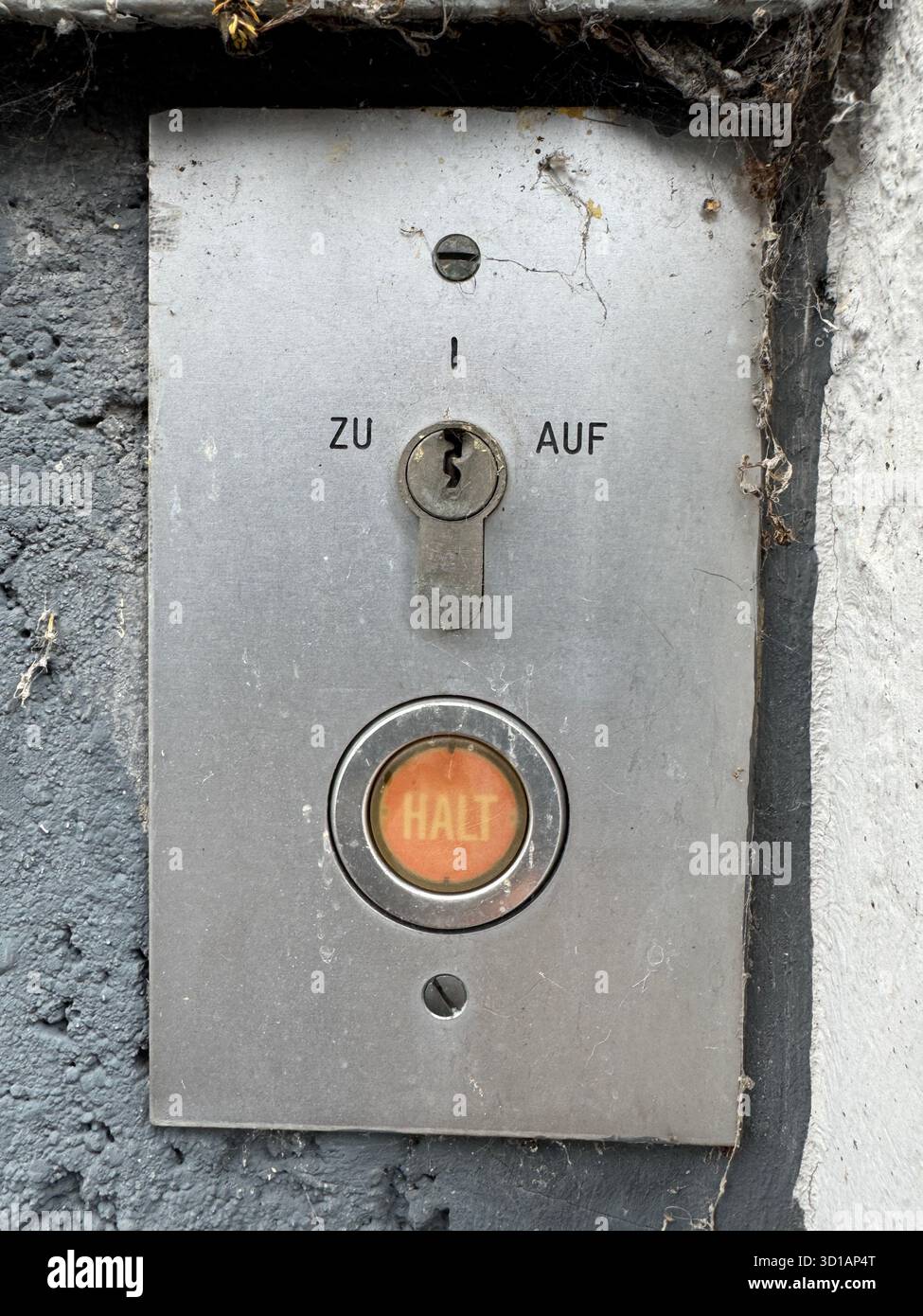 Silver button with a keyhole and the word "Halt" on it Stock Photo - Alamy
