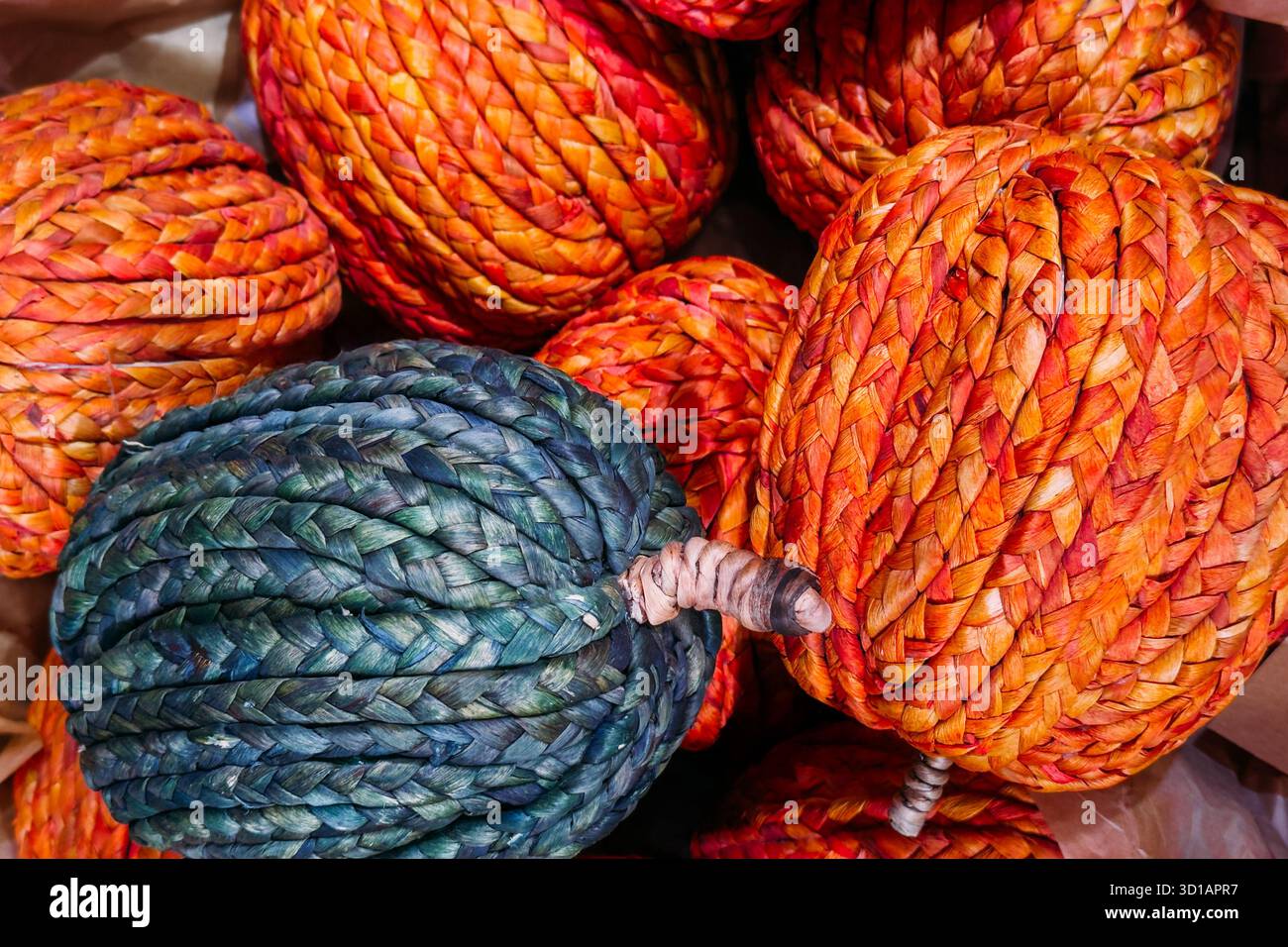 Colorful woven pumpkins made from braided natural fibers in shades of ...
