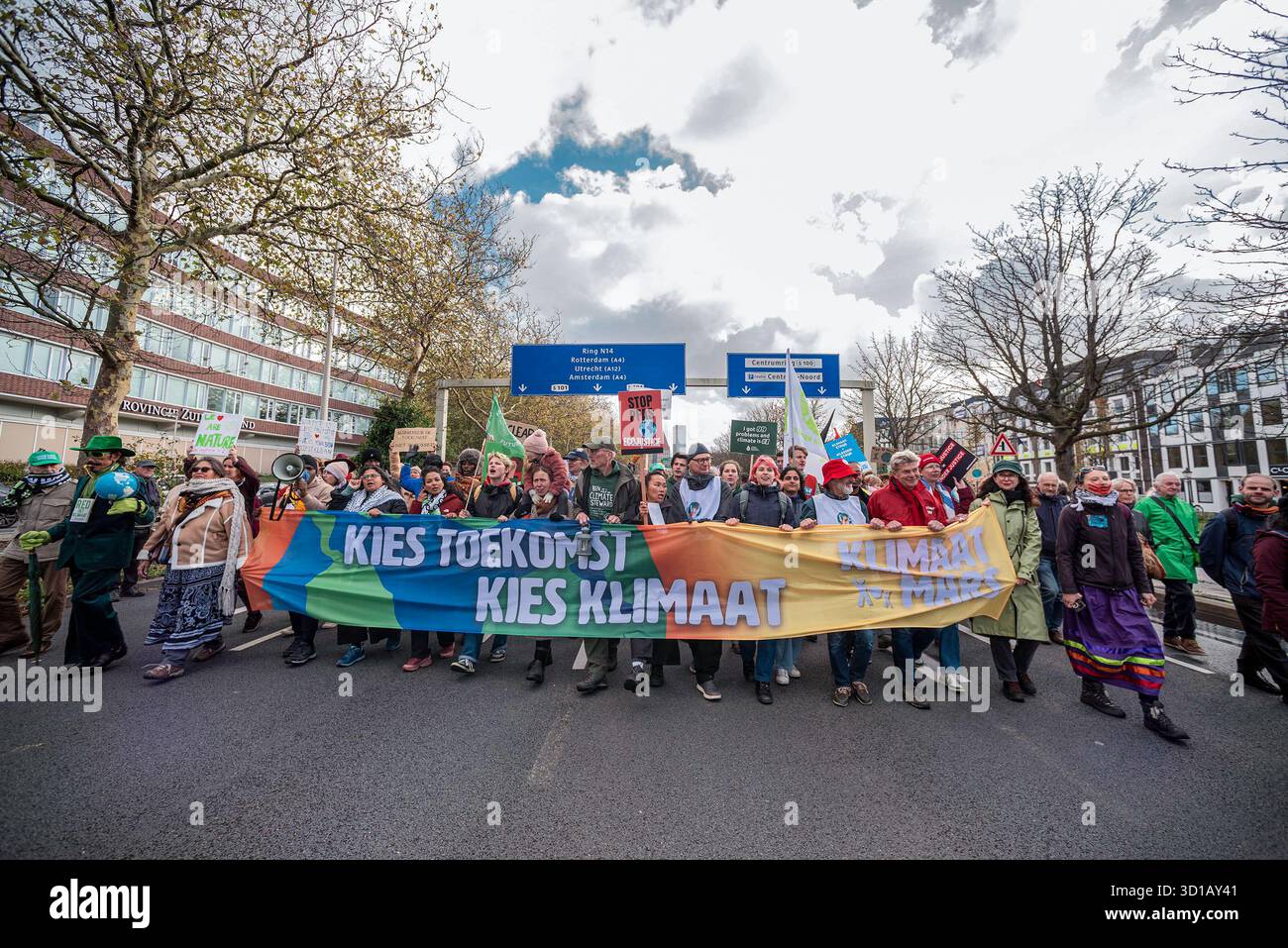 Demonstrators walk along the Koningskade with flags, banners and ...