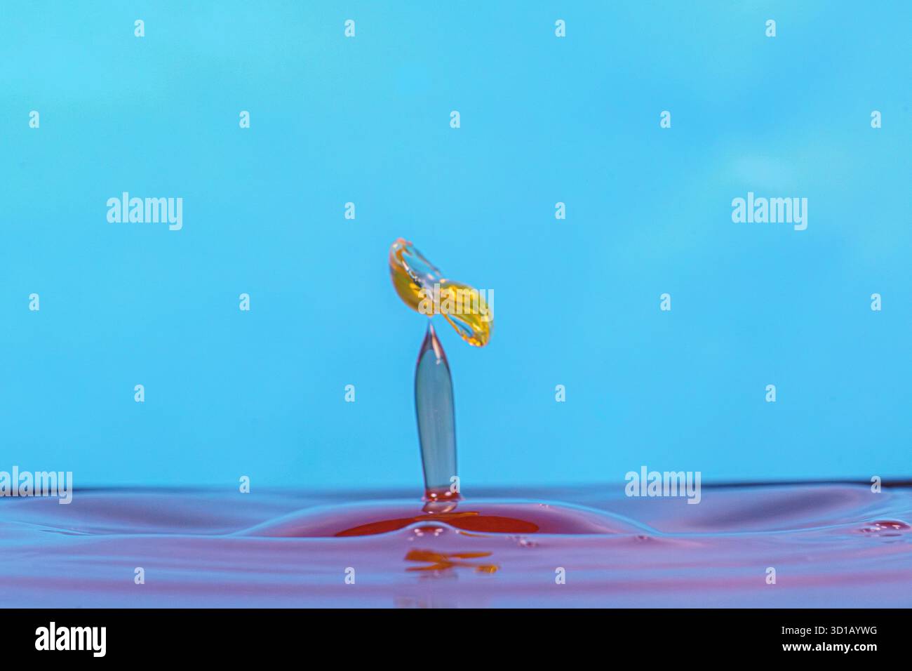 Vertical Splash with Crown Droplet Stock Photo - Alamy