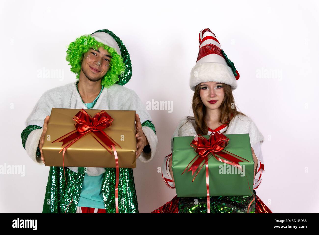 The two person dressed as elves are holding Christmas presents Stock ...
