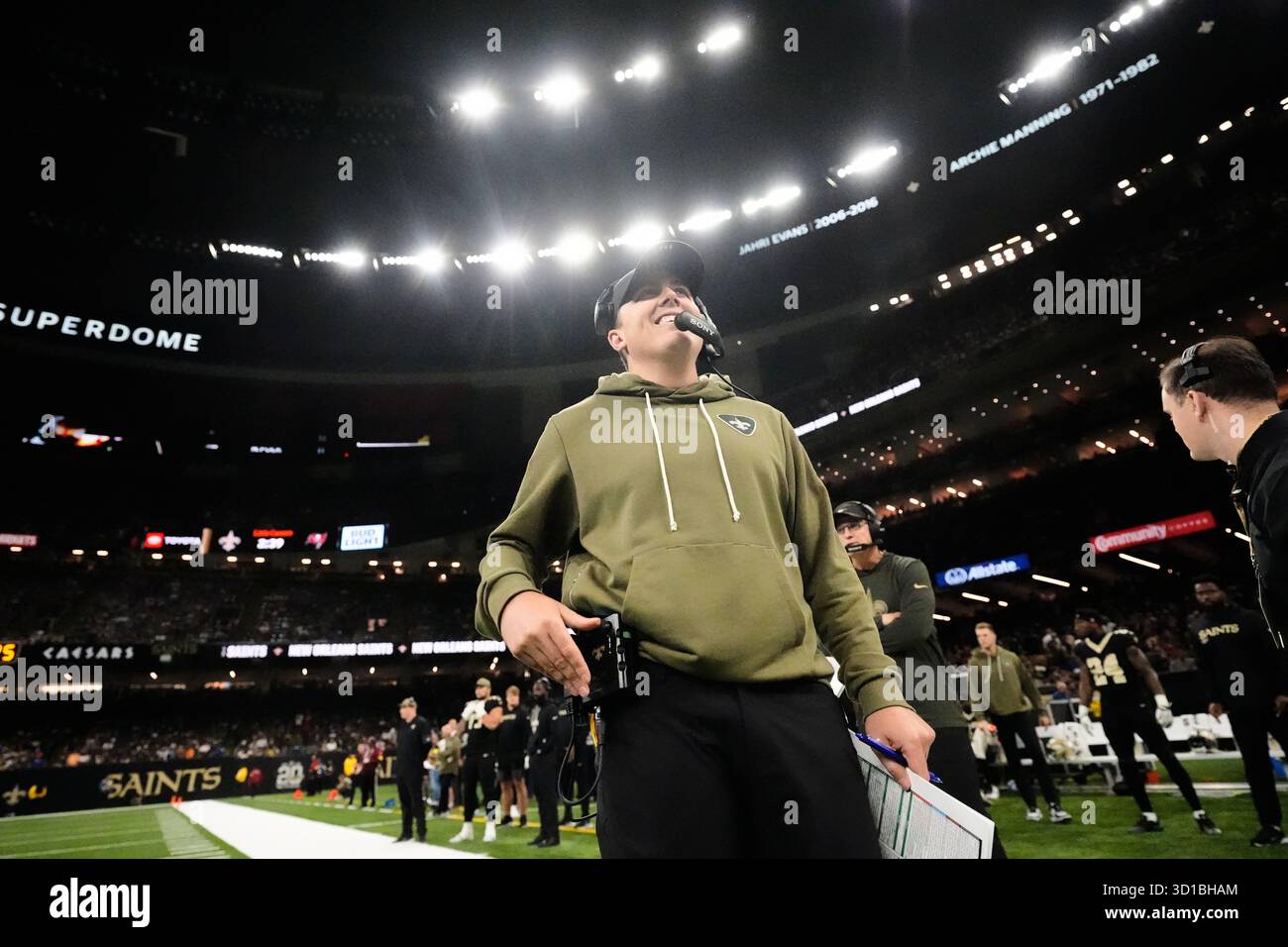 New Orleans Saints head coach Kellen Moore stands on the field before ...
