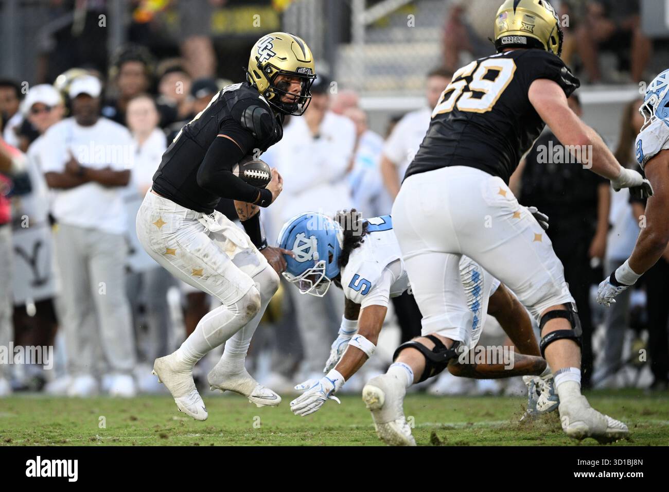 Central Florida quarterback Tayven Jackson, left, scrambles away from ...