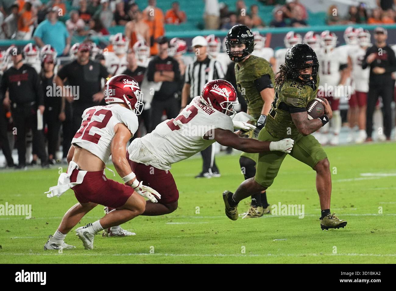 Miami running back Girard Pringle Jr., right, runs as Stanford safety ...
