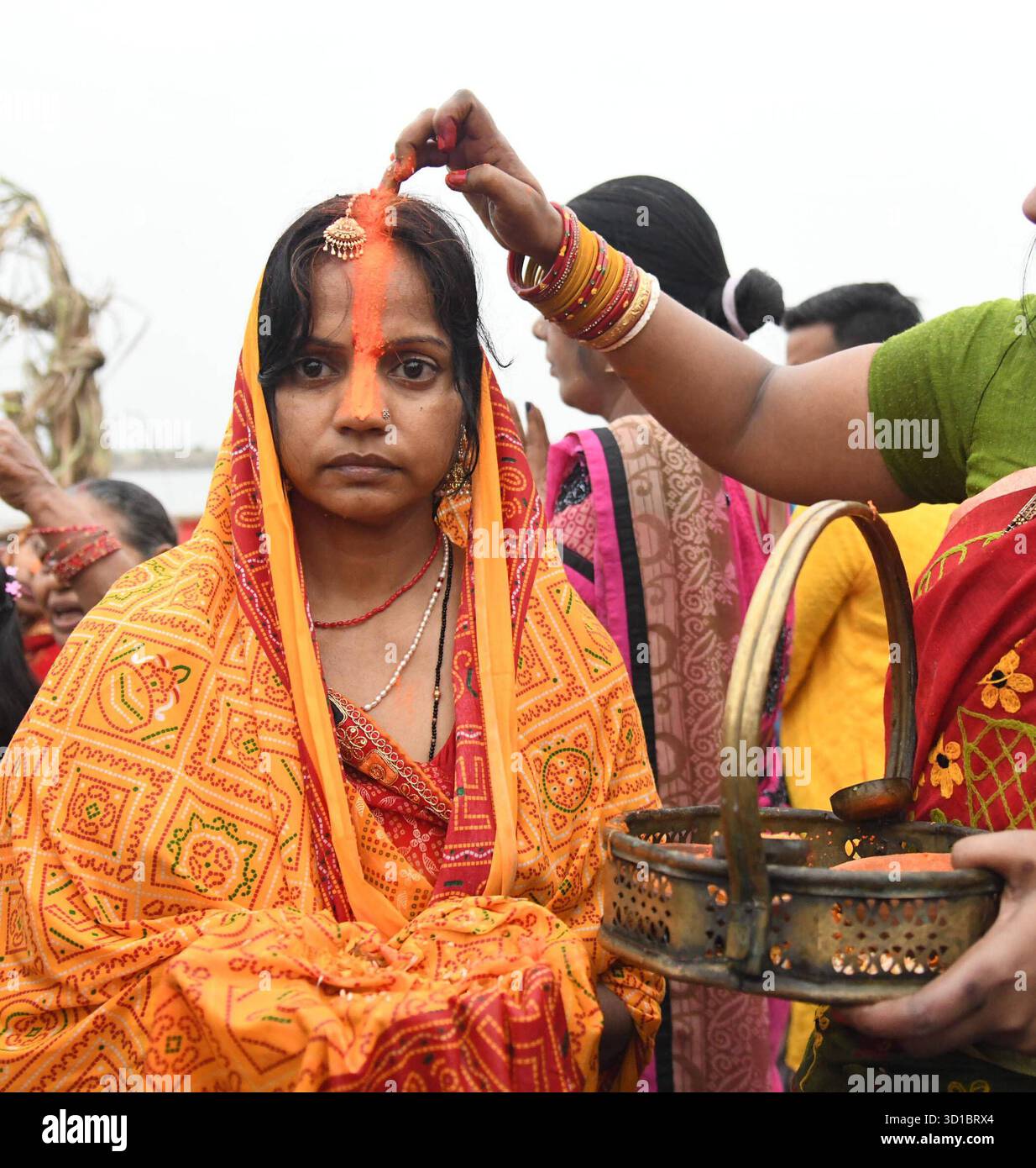 PATNA, INDIA - OCTOBER 27: Women devotees applying vermilian powder ...