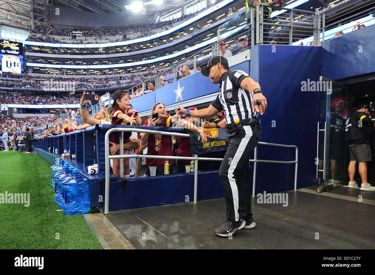 Side judge James Coleman greets fans as he walks onto the field for an ...