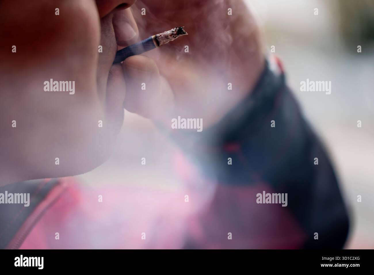 Cigarette smoke rising from smoker’s hand illustrating nicotine ...